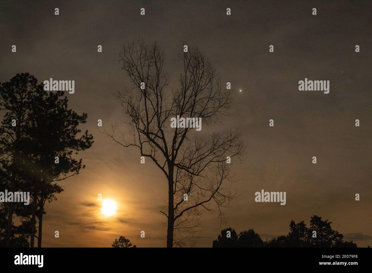 Full moon with Jupiter rising before a storm Stock Photo - Alamy