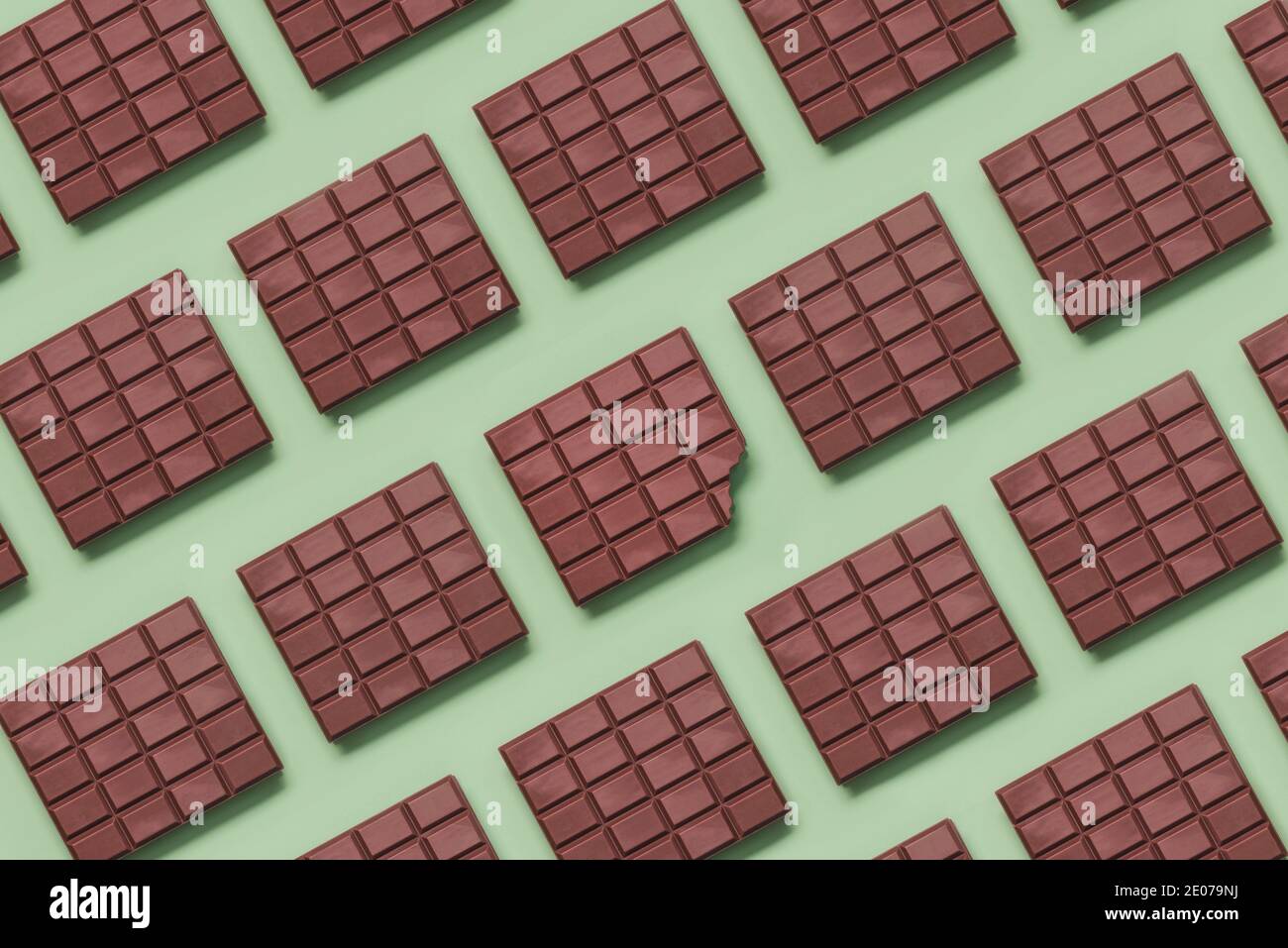Geometric pattern made with chocolate bars and in the center a bitten ...