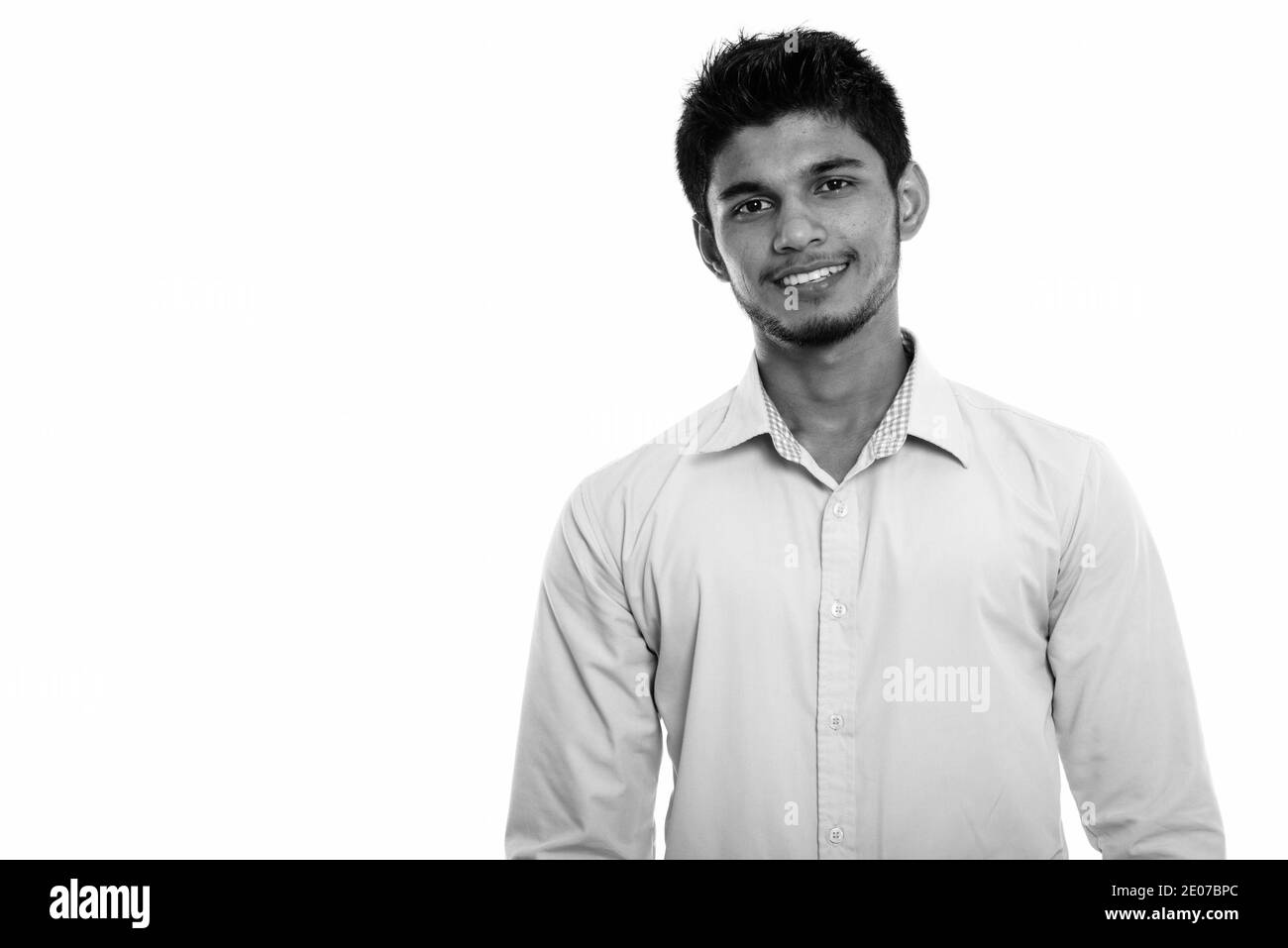 Studio shot of young happy Indian man smiling Stock Photo - Alamy