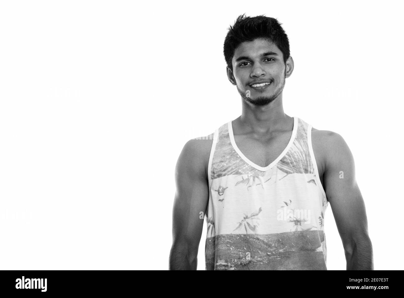 Studio shot of young happy Indian man smiling Stock Photo - Alamy