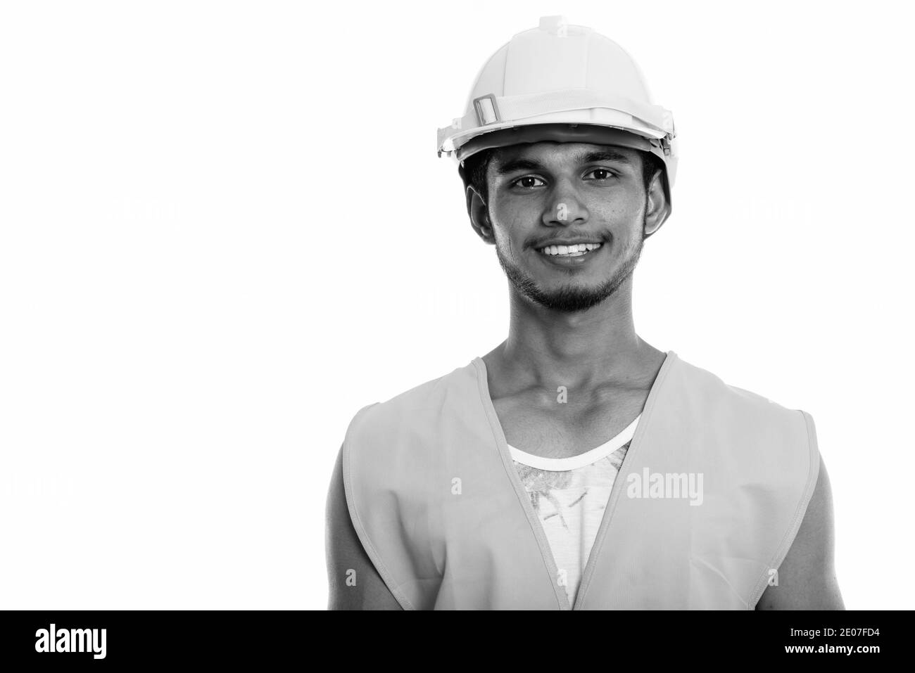 Studio shot of young happy Indian man construction worker smiling Stock ...