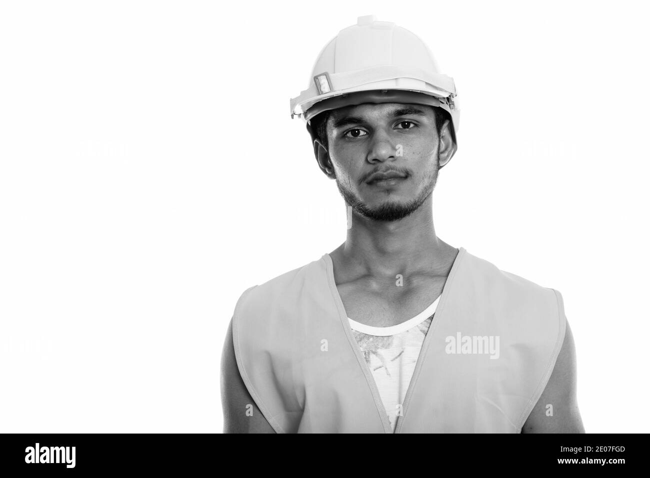 Studio shot of young handsome Indian man construction worker Stock ...