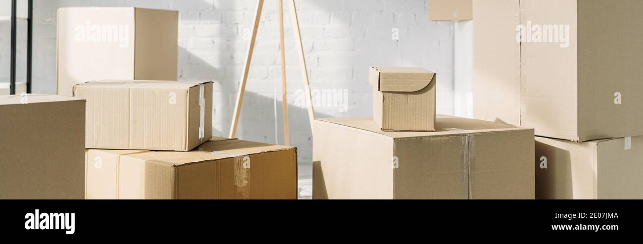 stack of carton boxes in modern apartment, banner Stock Photo - Alamy