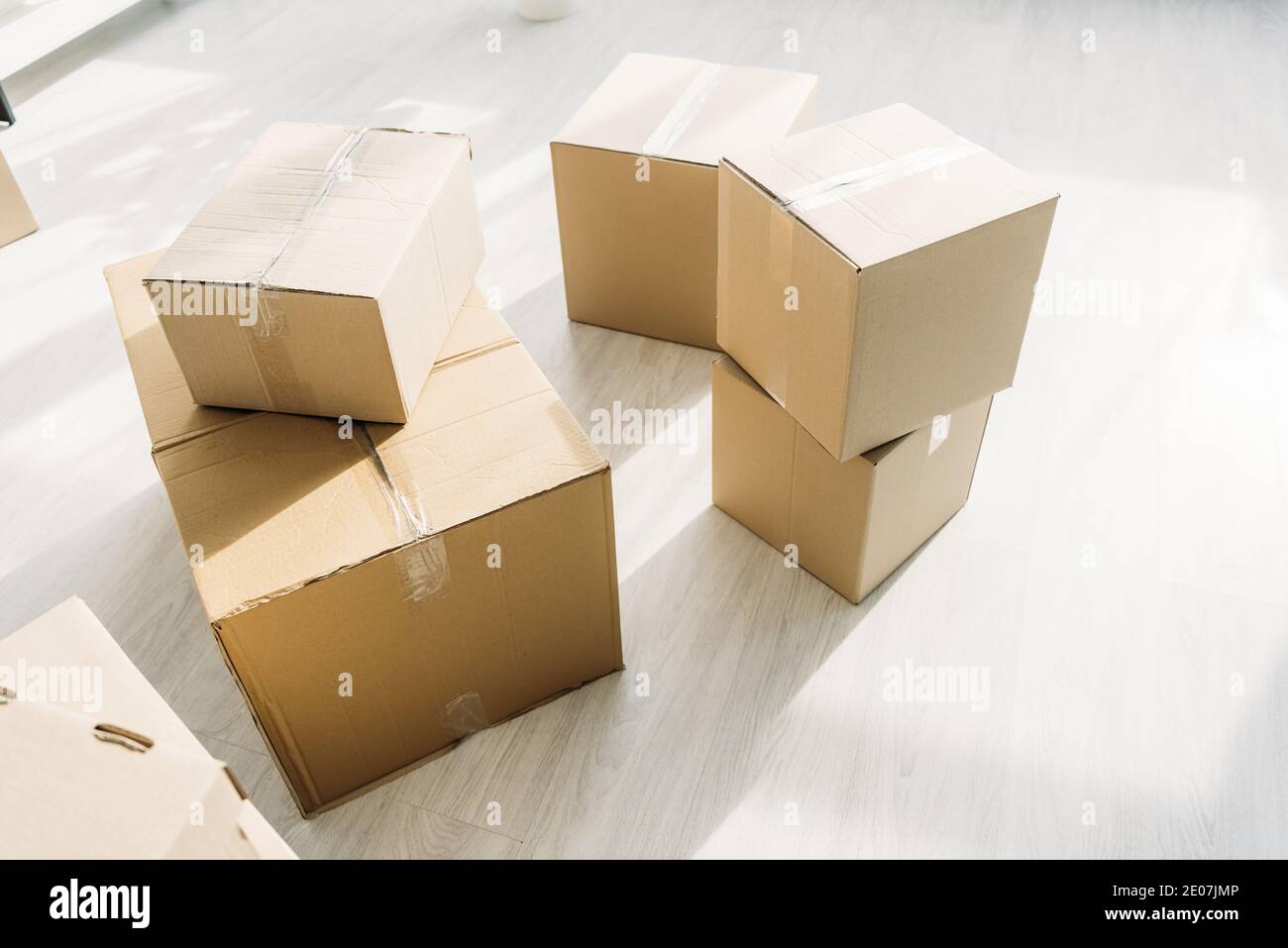 stacked carton boxes on floor in modern apartment Stock Photo - Alamy