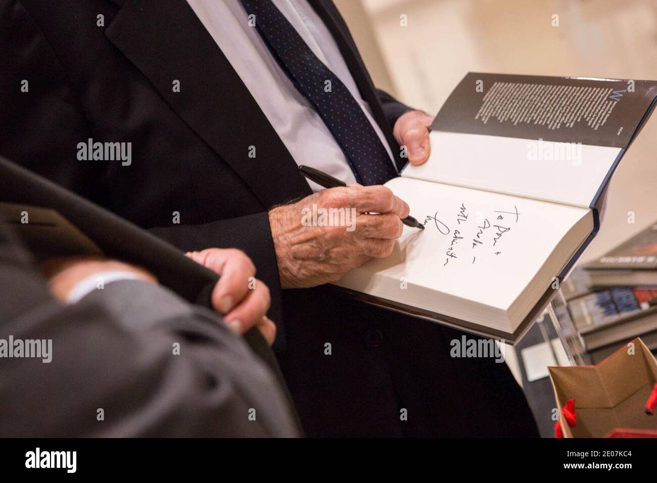 Lee H. Hamilton, a former U.S. Representative from Indiana, signs a ...