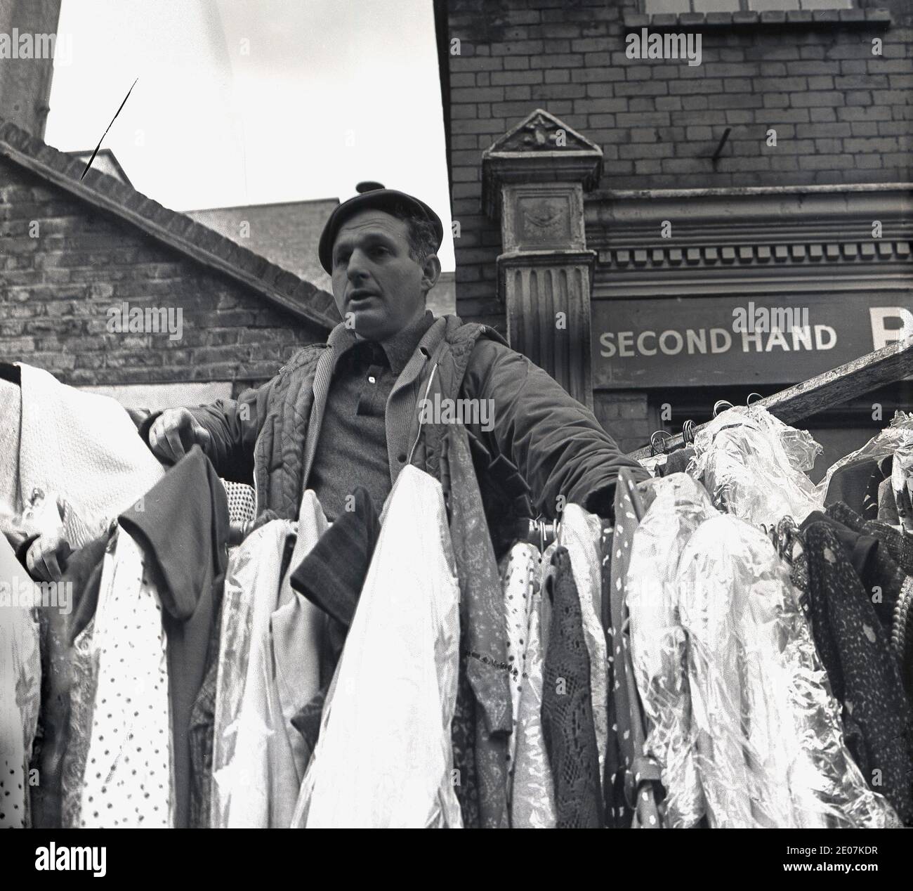 1960s, historical, outside at an open-air market, a male street trader ...