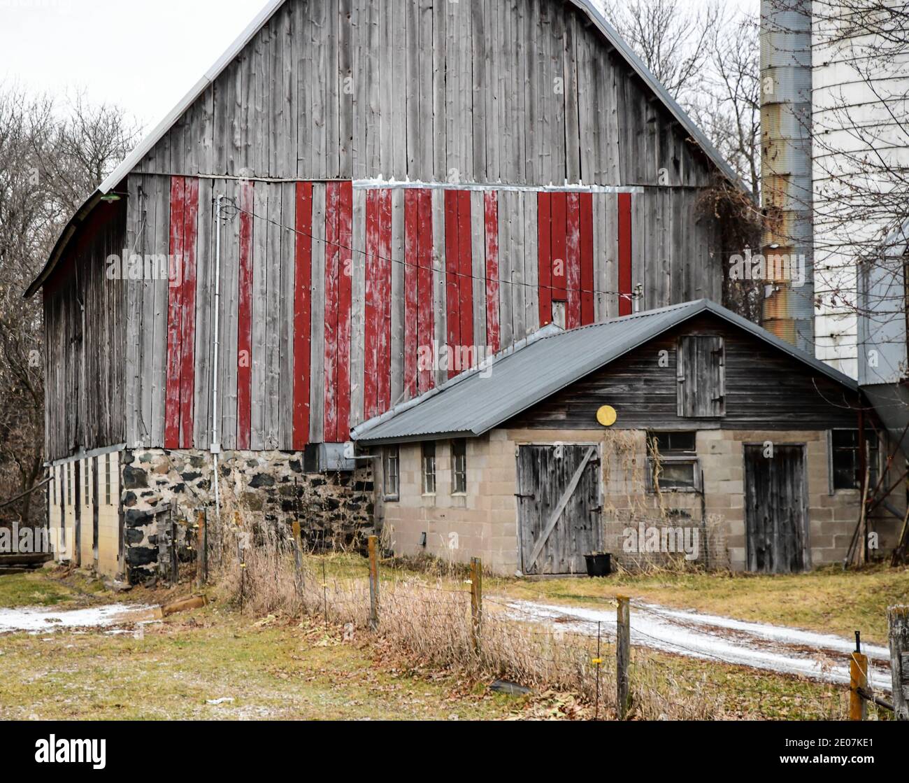 weathered wooden old farm agricultural barn in the winter farmland ...