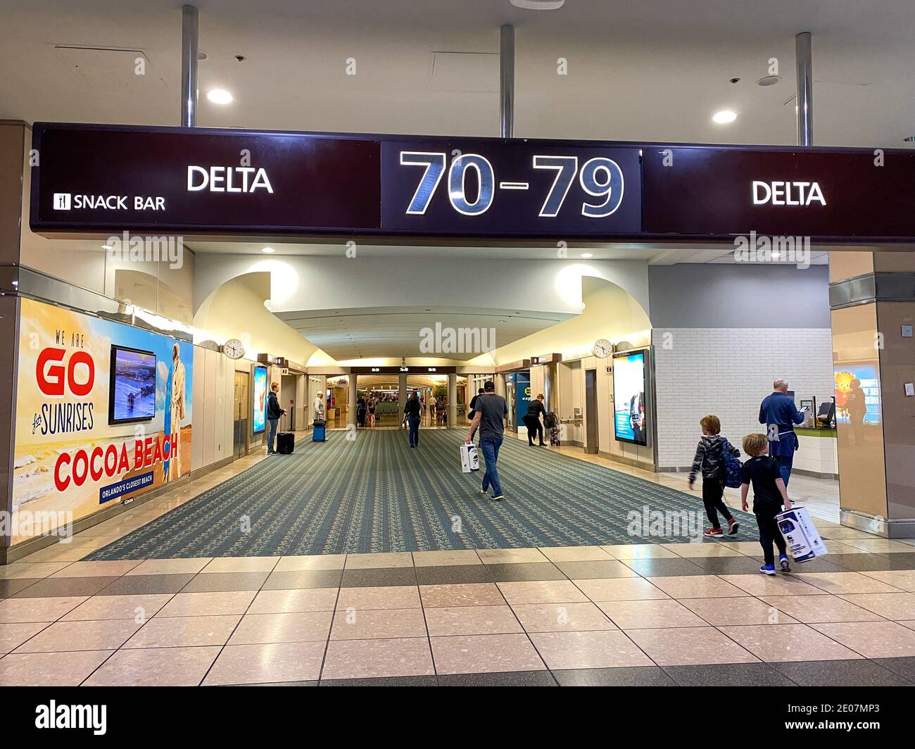 Orlando, FL USA - February 19, 2020: People walking to Delta departure ...