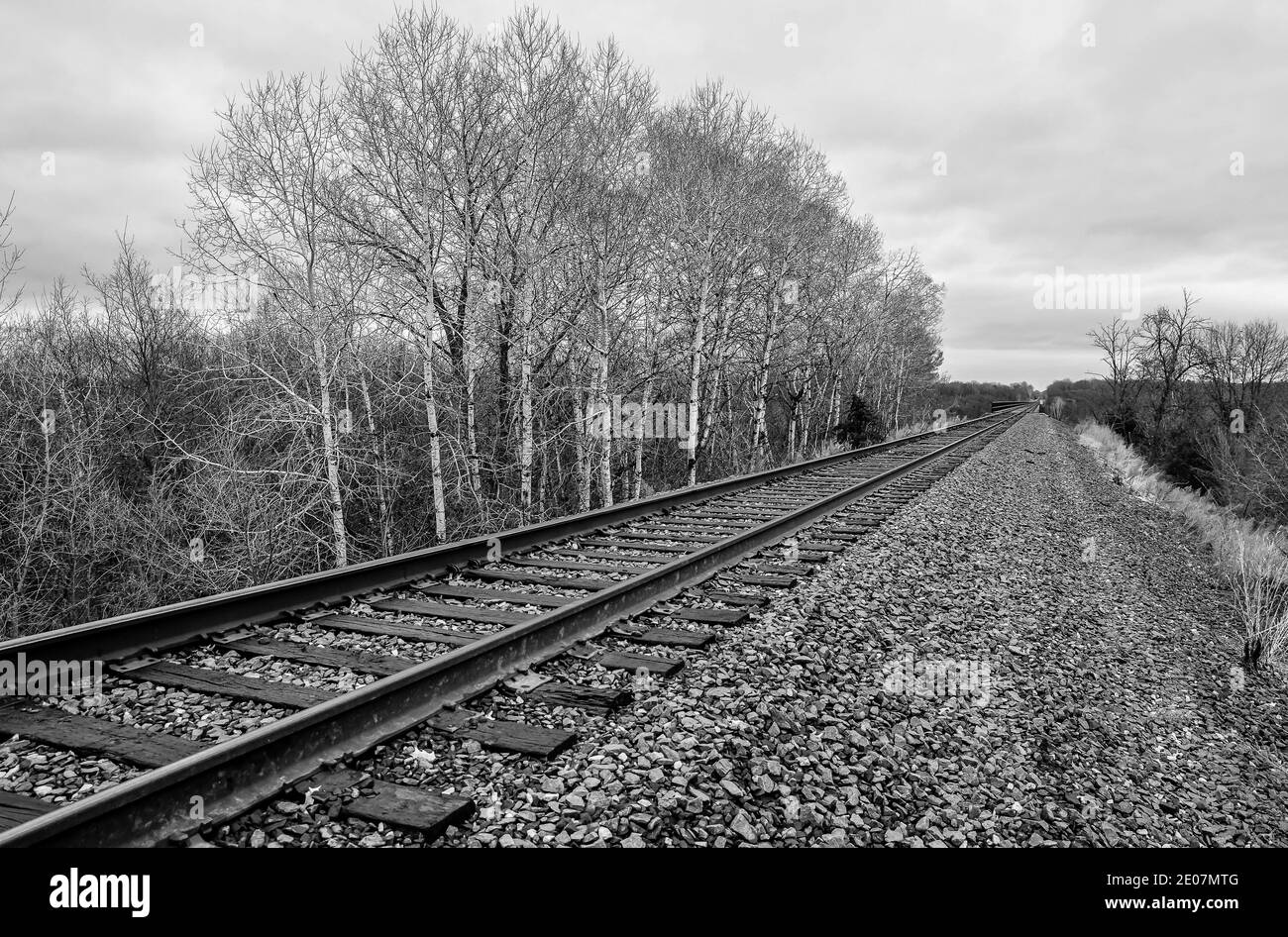 Looking down empty steel railroad train tracks Stock Photo - Alamy
