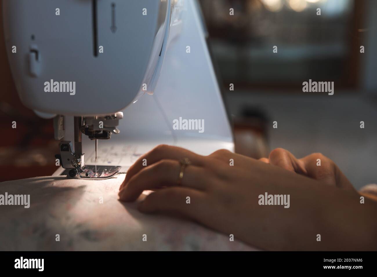 Young woman using a sewing machine Stock Photo - Alamy