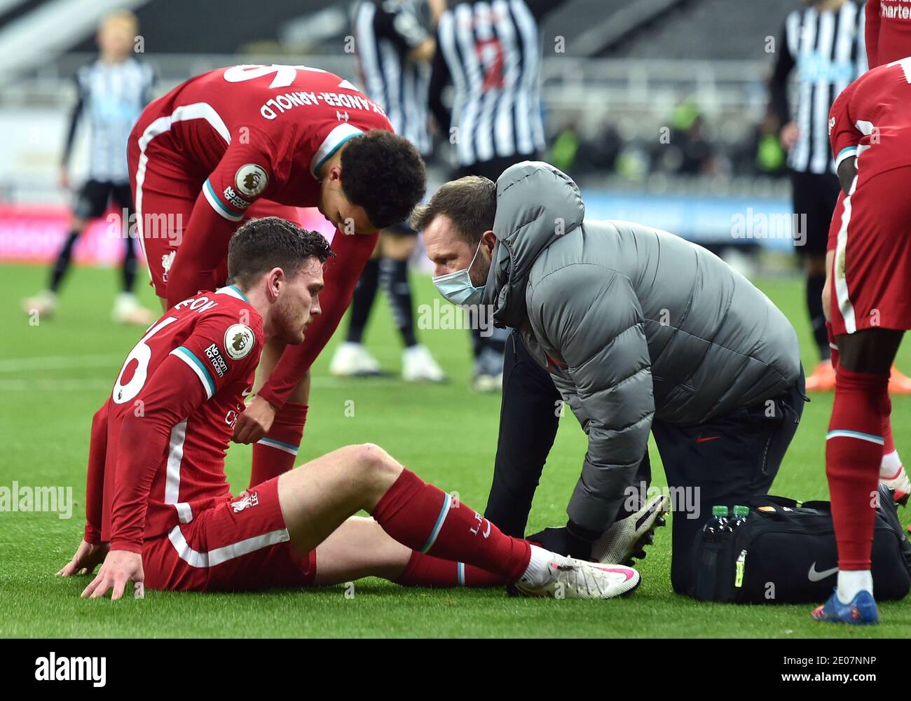 Liverpool's Andrew Robertson receives treatment for an injury during ...