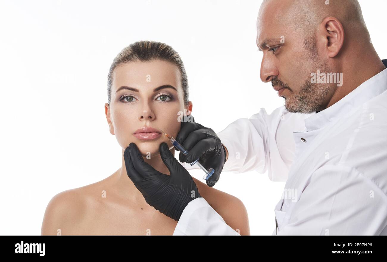 Beautiful young woman getting injection. Portrait on a white background ...
