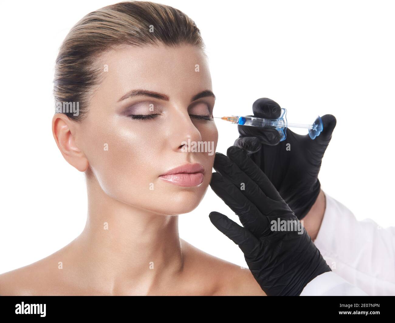 Beautiful woman gets an injection in her face isolated on white Stock ...