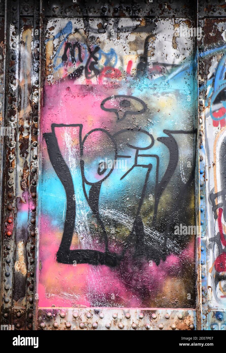 street art graffiti on the rusty old iron railway bridge and steel grid ...