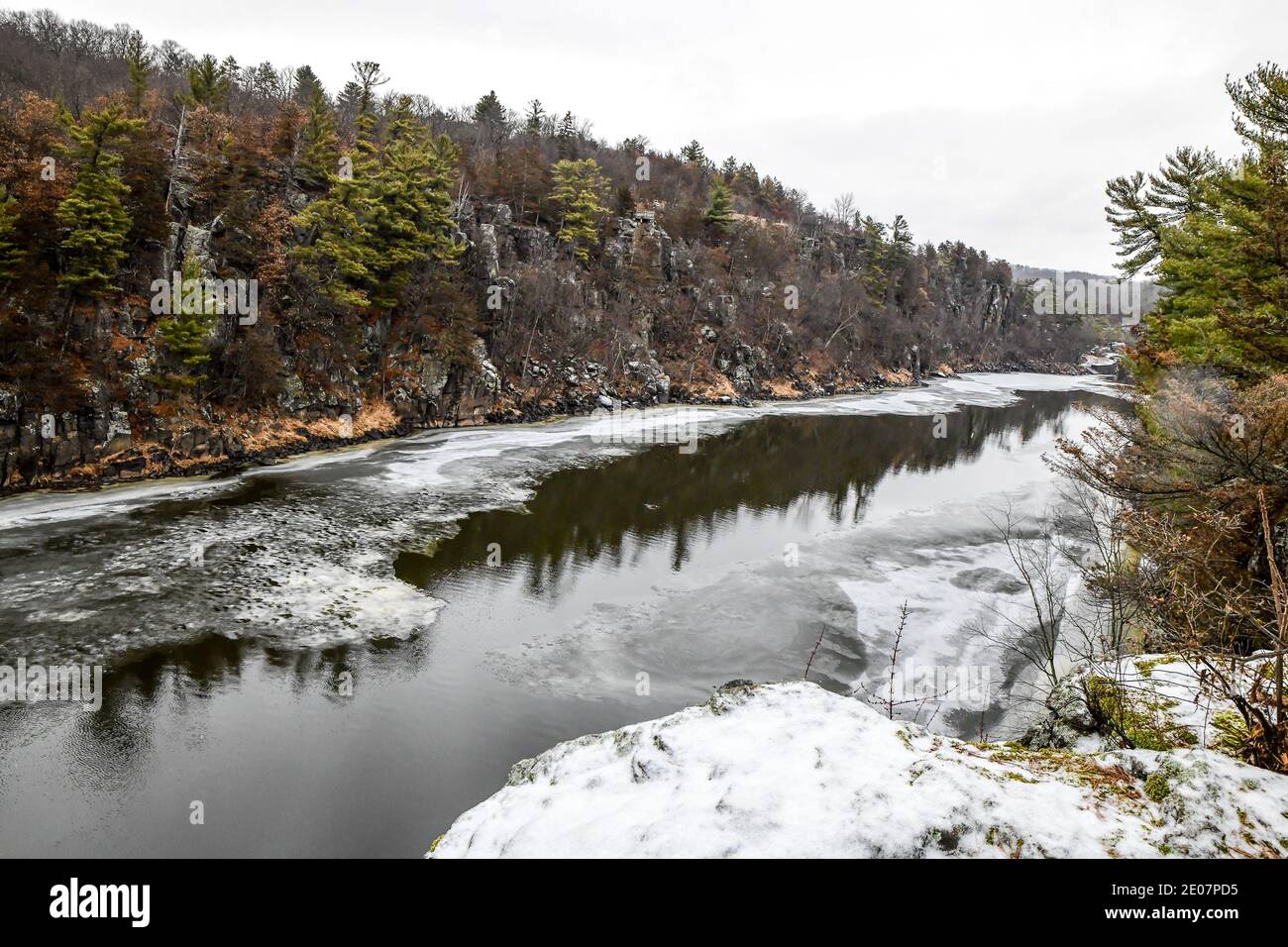 Icy snow and rocks along the river forest and trees in winter Stock ...