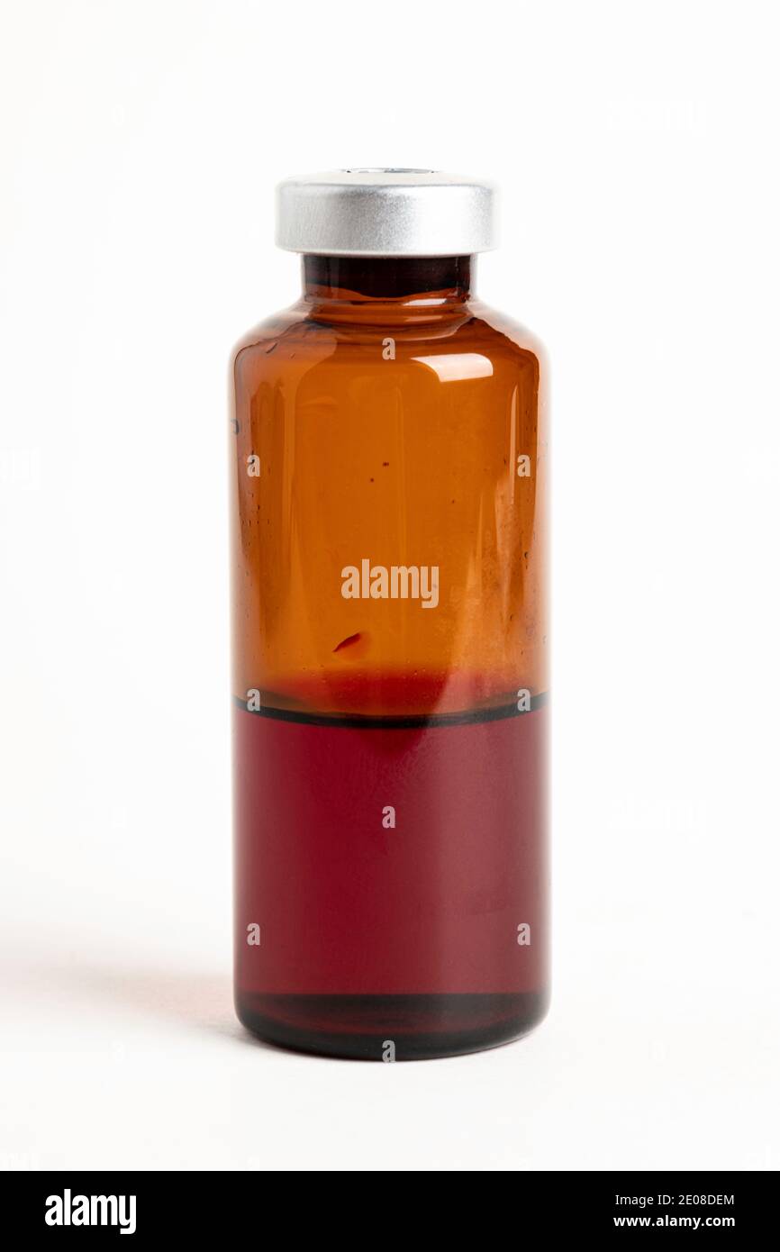 A macro shot with selective focus of an amber color vaccine injection ...