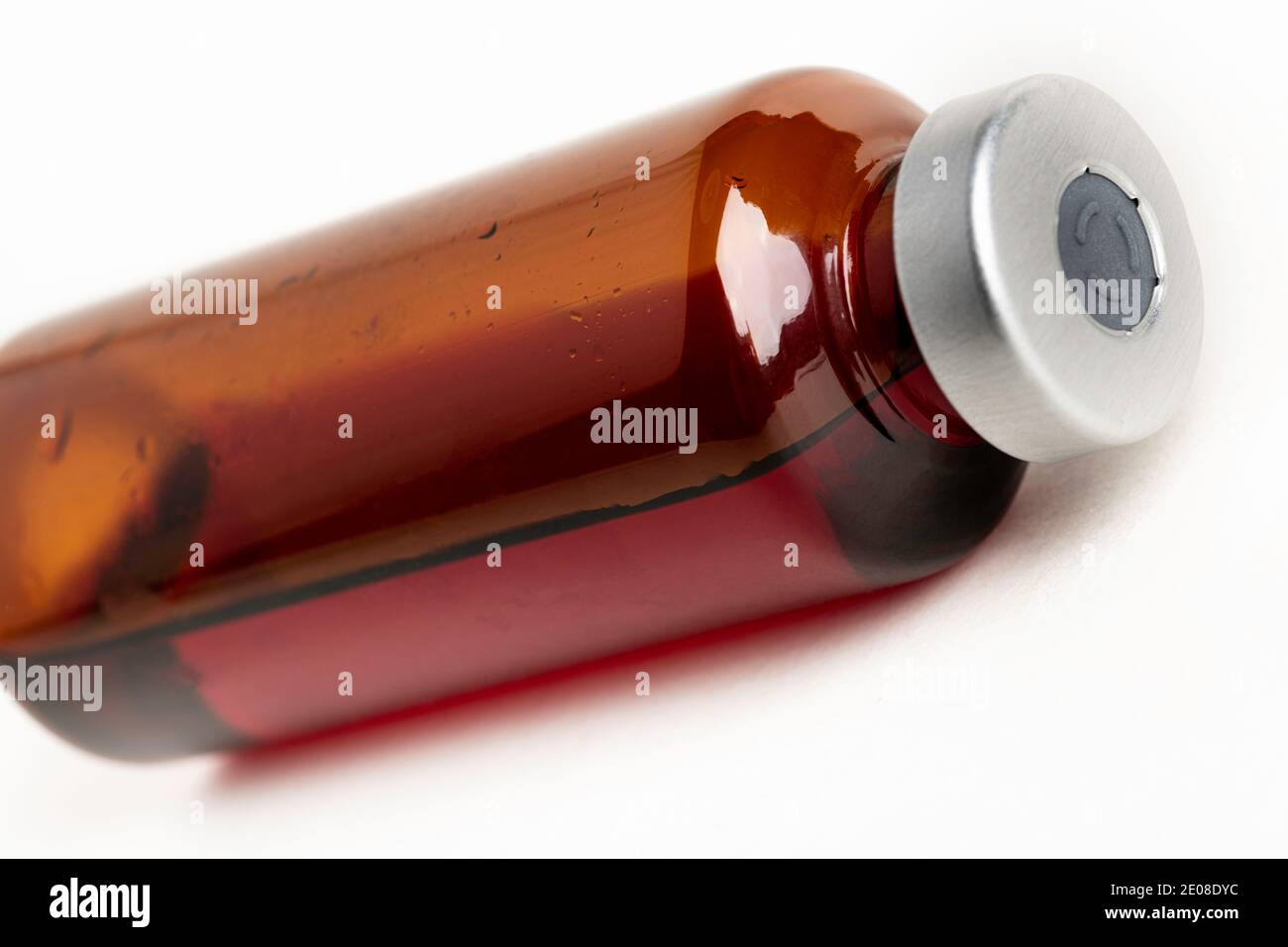 A macro shot with selective focus of an amber color vaccine injection ...
