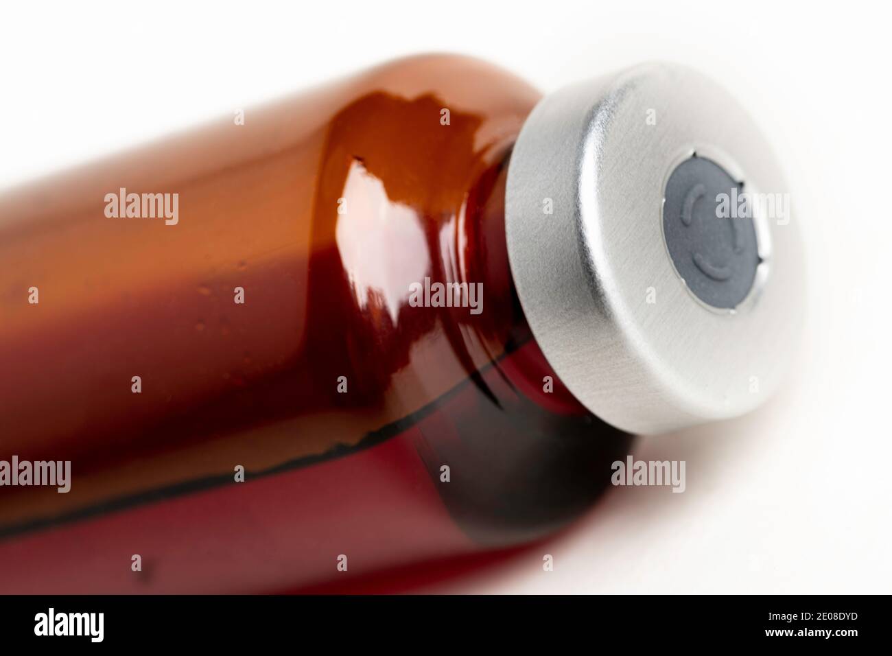 A macro shot with selective focus of an amber color vaccine injection ...