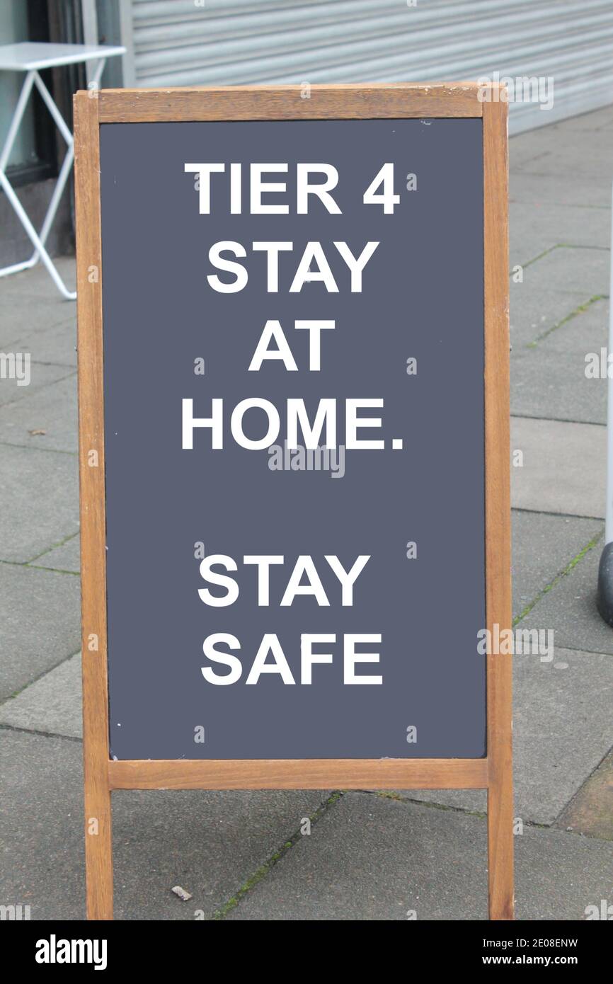 Tier 4 stay at home, stay safe Covid message on a chalk board Stock ...