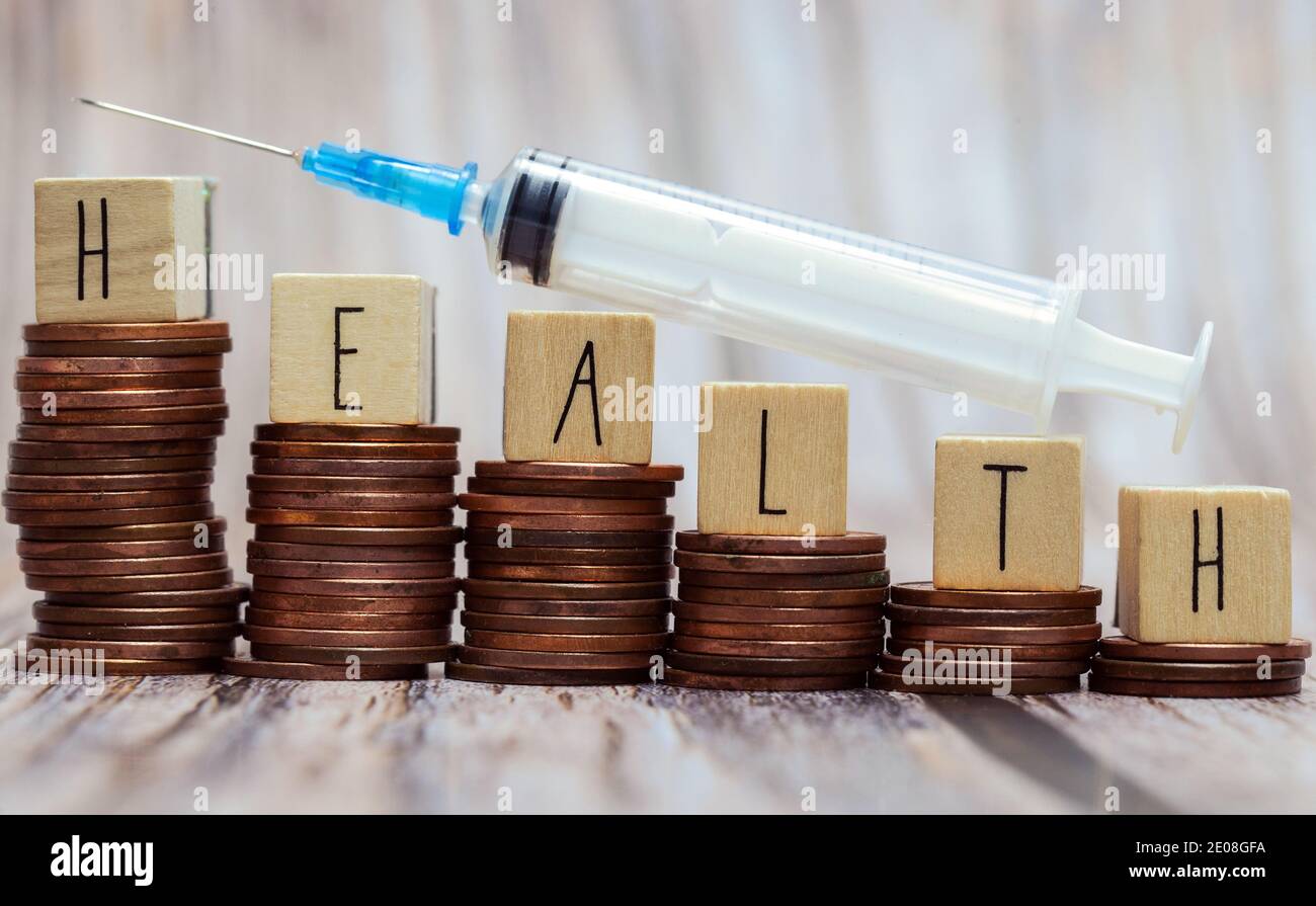 Word HEALTH on step stacked coins with syringe for injection, Money ...