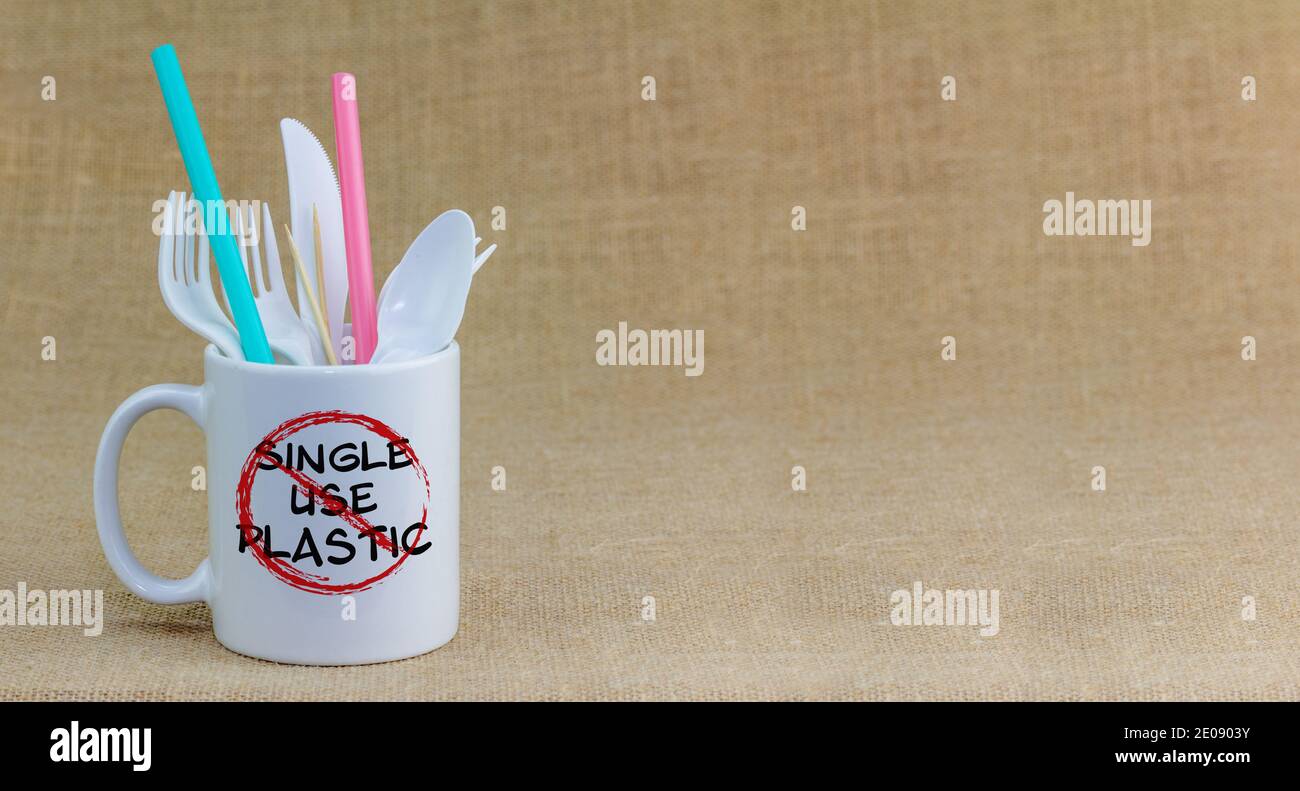 Single use plastic text crossed out on mug of single use plastic items ...