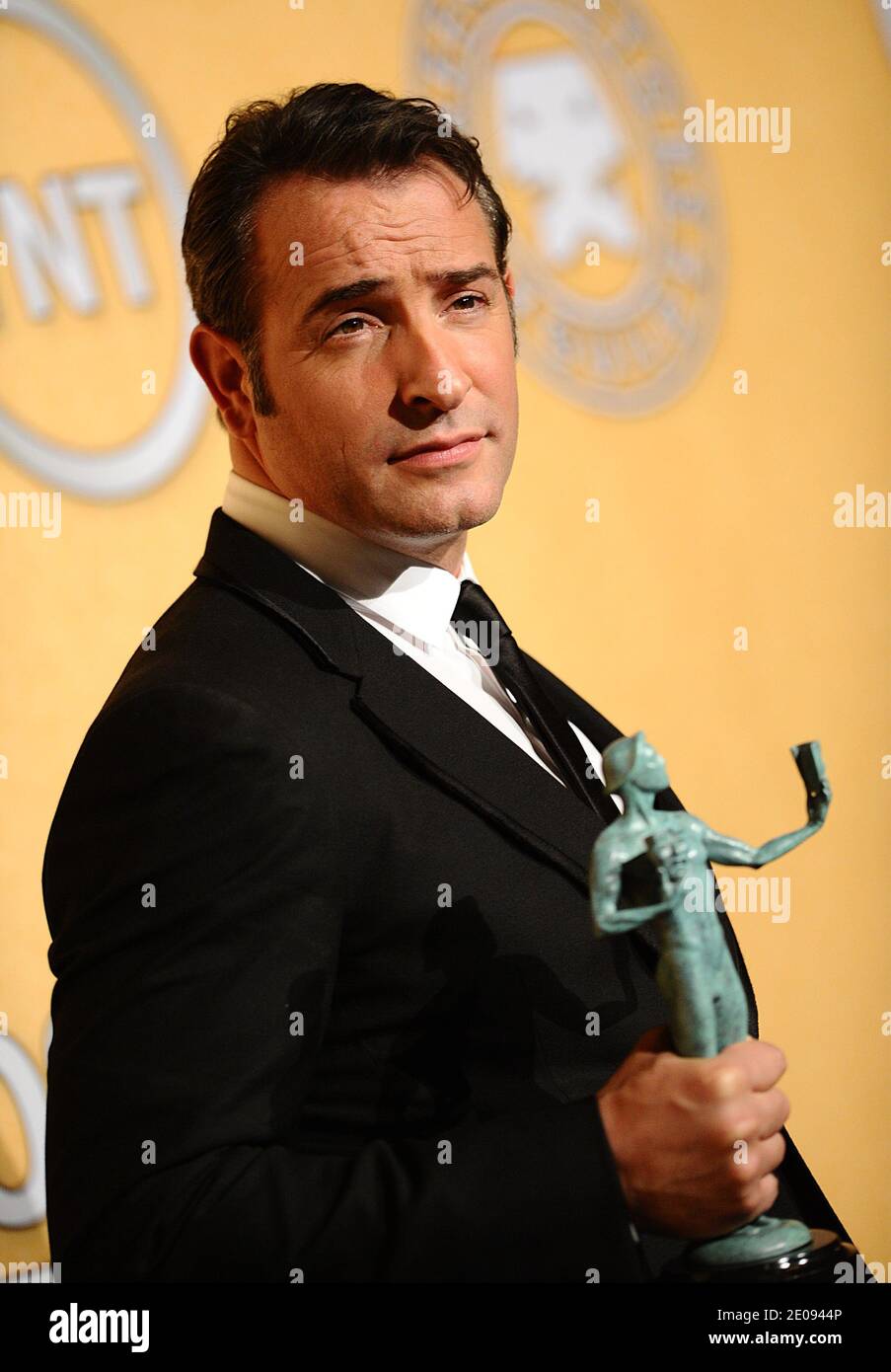 Jean Dujardin poses in the press room with the Outstanding Performance ...