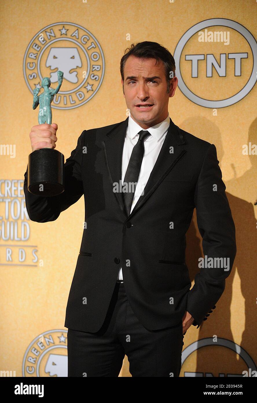 Jean Dujardin poses in the press room with the Outstanding Performance ...