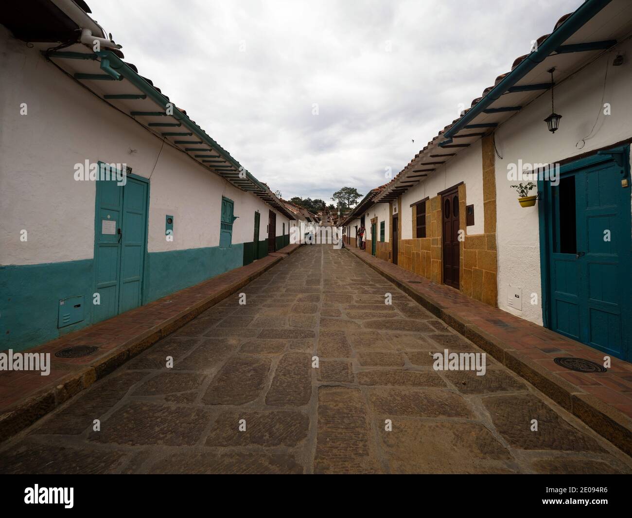 Classic white house walls and cobblestone streets in colonial ...