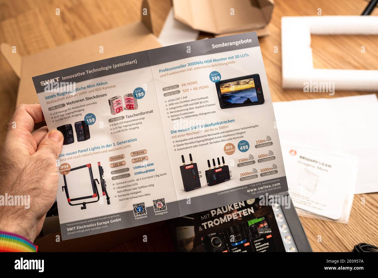 Paris, France - Dec 8 2020: POV male hand reading flyer with multiple ...