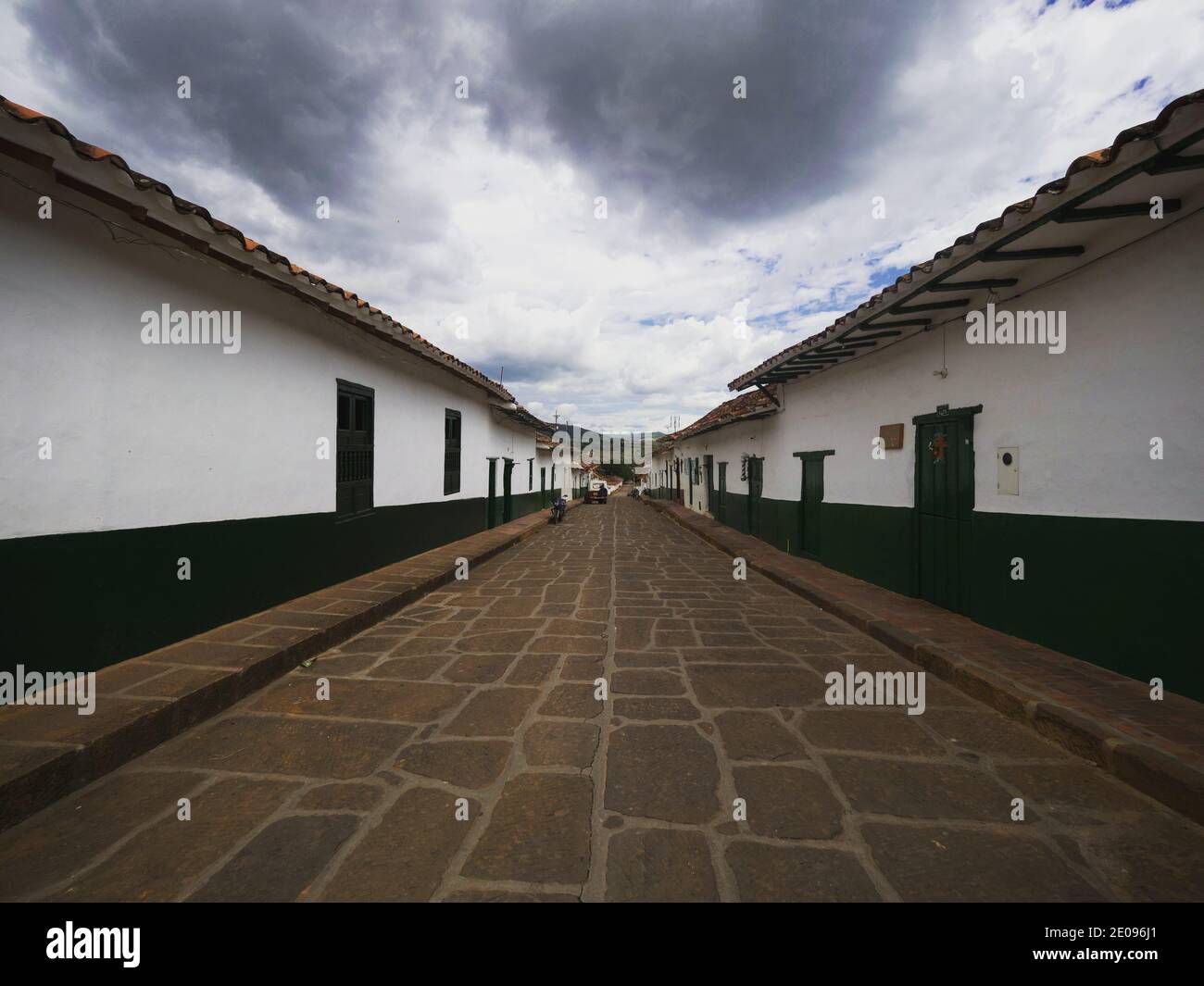 Classic white house walls and cobblestone streets in colonial ...