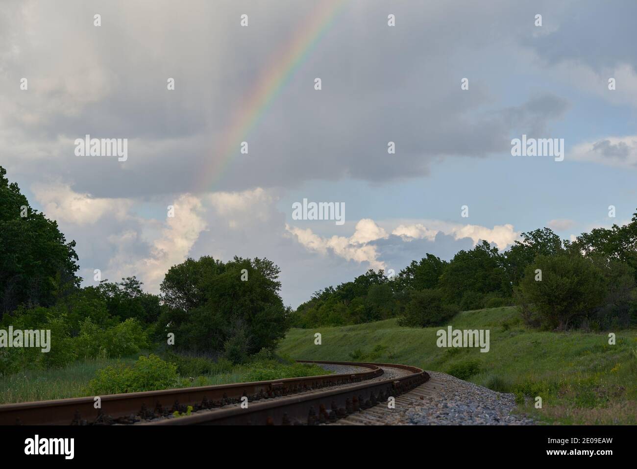 Rainbow in the rain on the railway Stock Photo - Alamy
