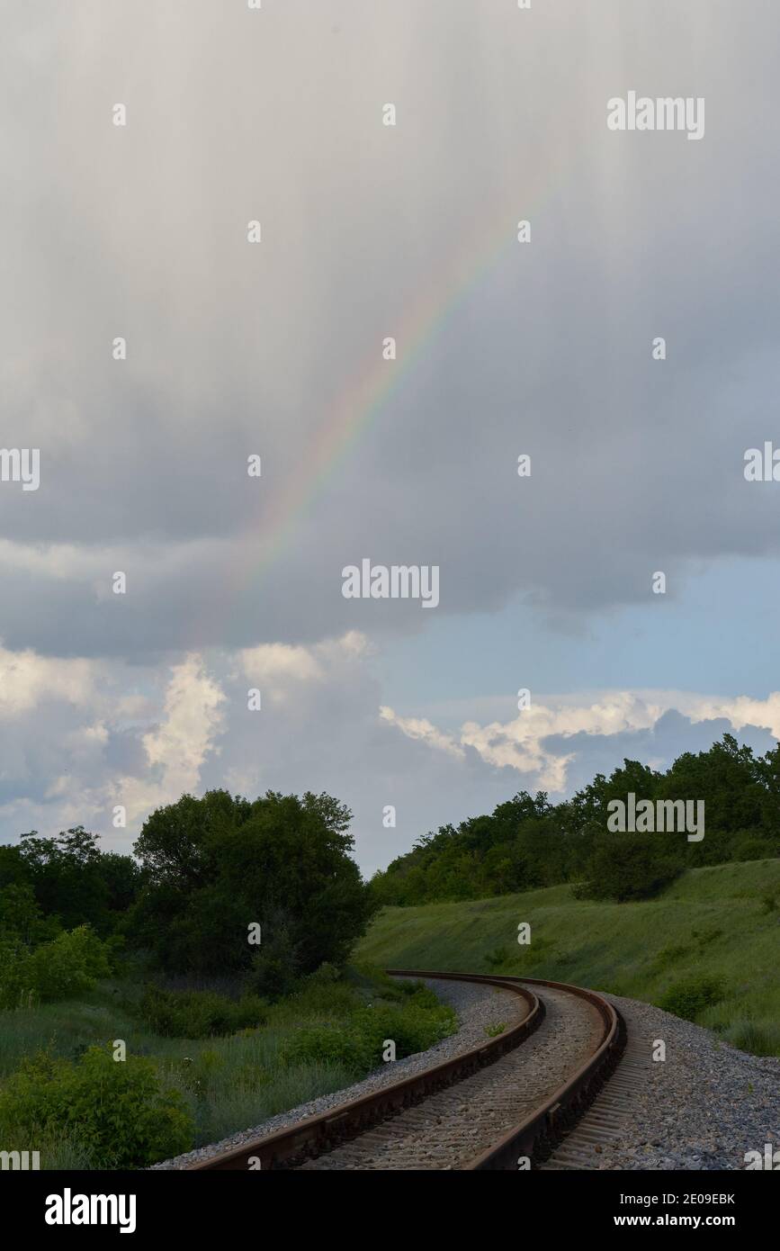 Rainbow in the rain on the railway Stock Photo - Alamy