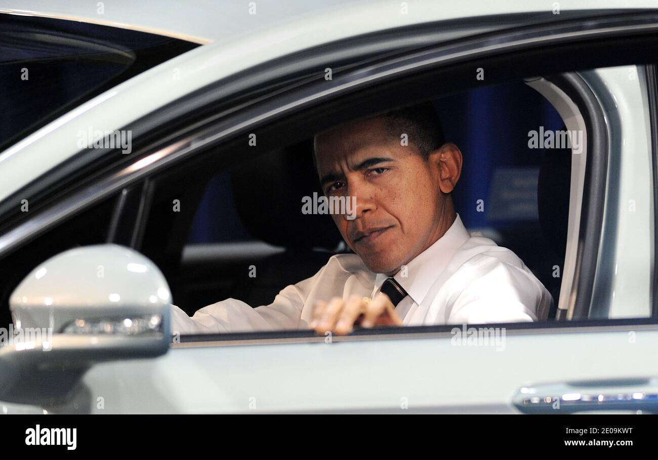 U.S. President Barack Obama looks at cars during a visit to the DC Auto ...
