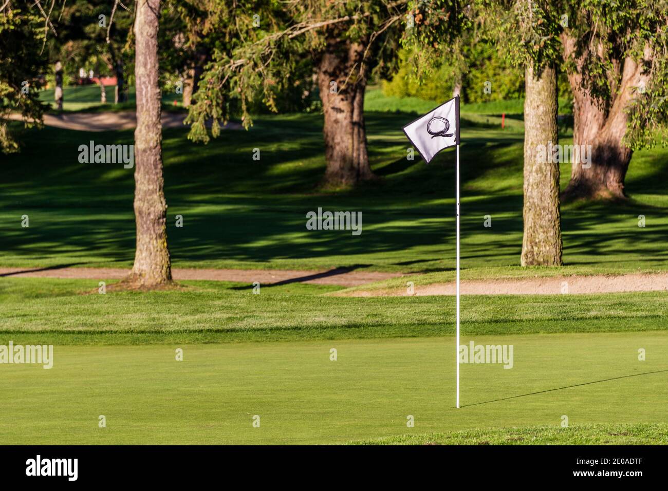 RICHMOND, CANADA - MAY 06, 2020: Golf course flag on the green field ...