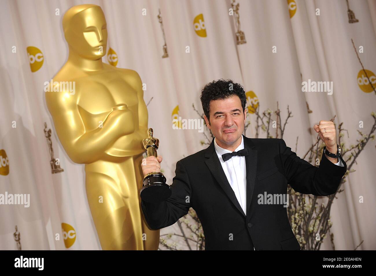 Ludovic Bource poses with the Best Original Score award in the press ...