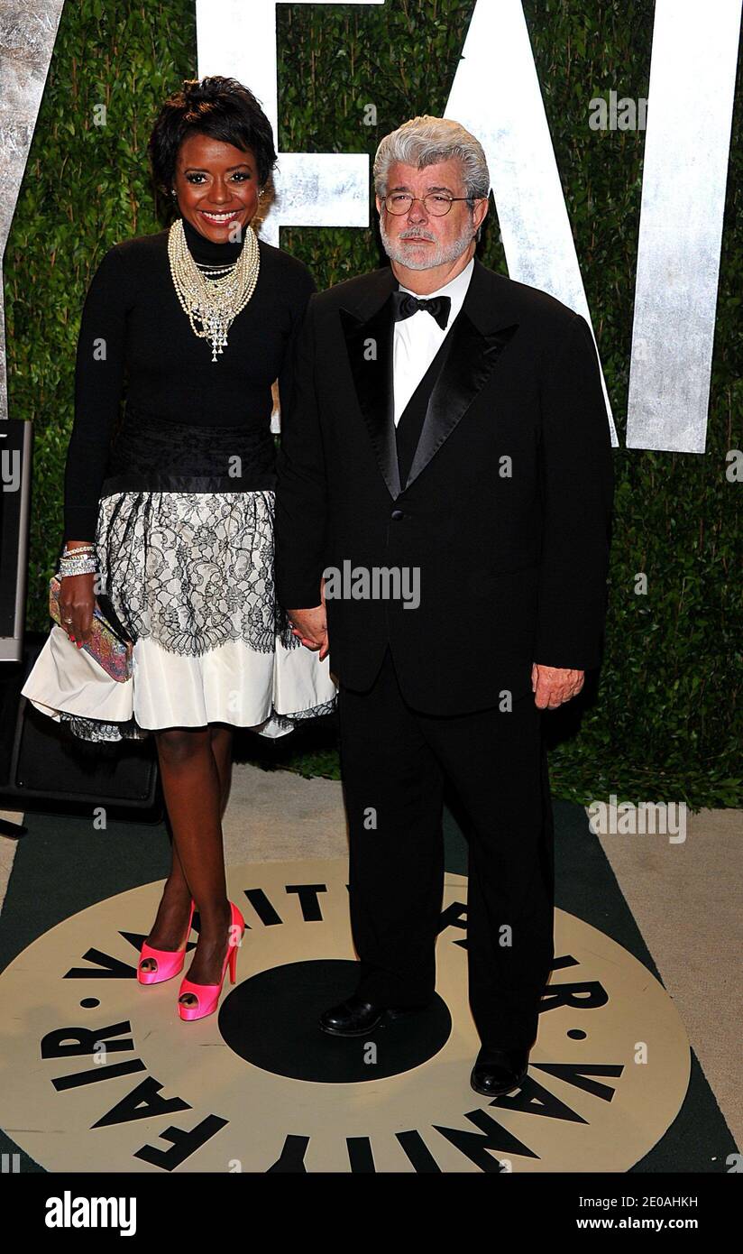 George Lucas and Melanie Hobbson arriving at the 2012 Vanity Fair Oscar ...