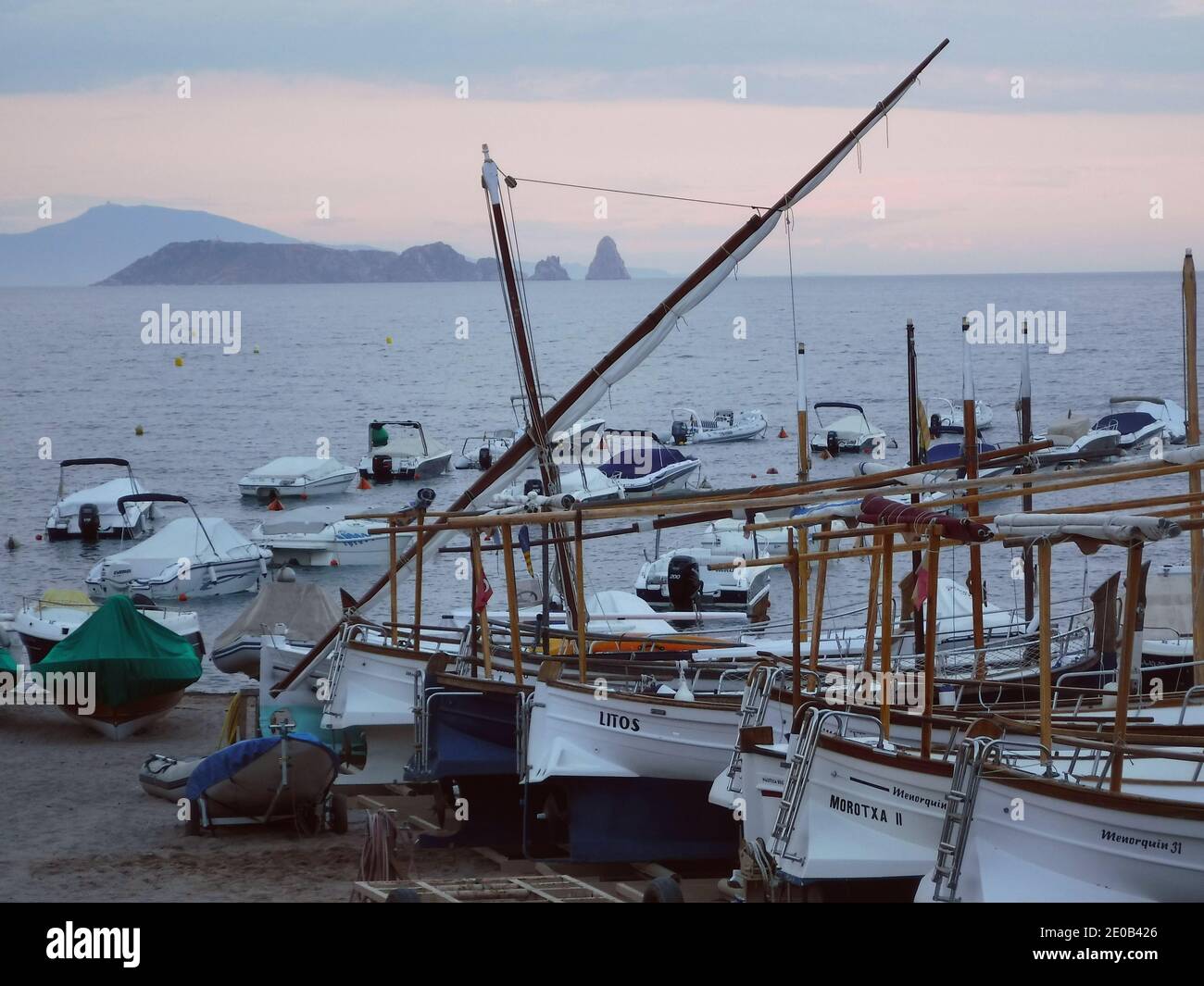 Fishing boats drawn up on the beach at Sa Riera in the Costa Brava ...