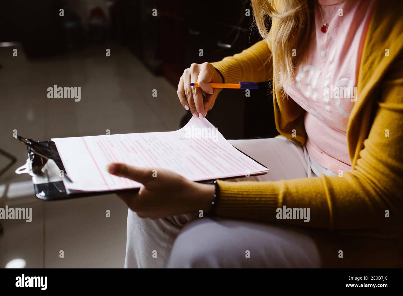 Latin woman hands writing and signing a document or a questionnaire in ...