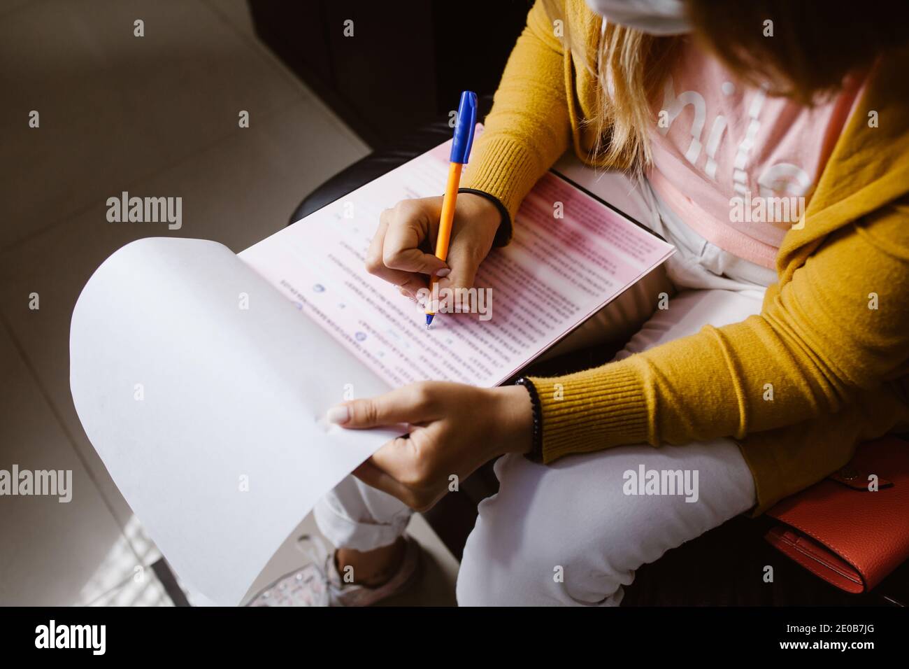 Latin woman hands writing and signing a document or a questionnaire in ...
