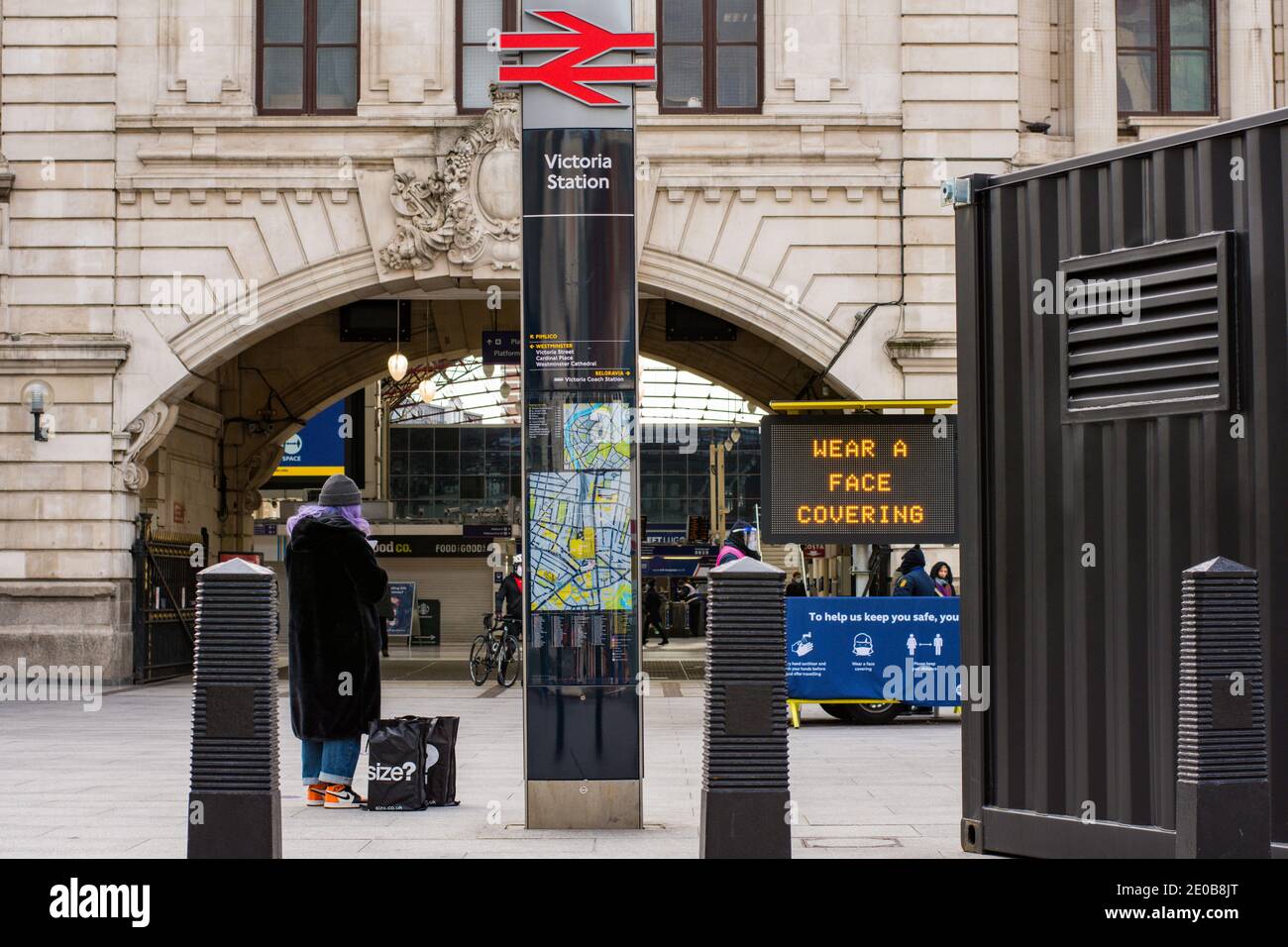 Victoria station sign face covering hi-res stock photography and images ...