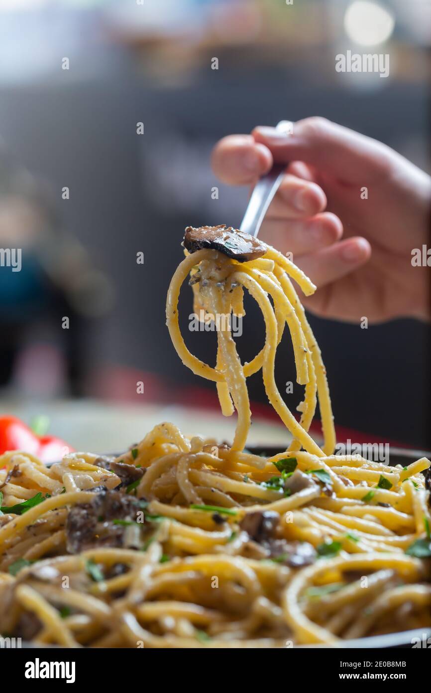 Close up man eating pasta hi-res stock photography and images - Alamy