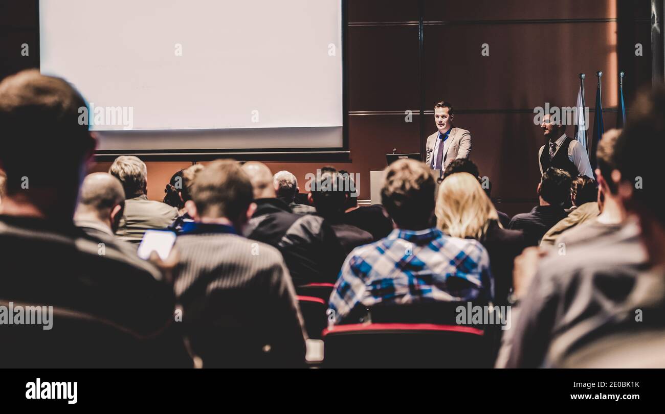 Business speaker giving a talk at business conference meeting event ...