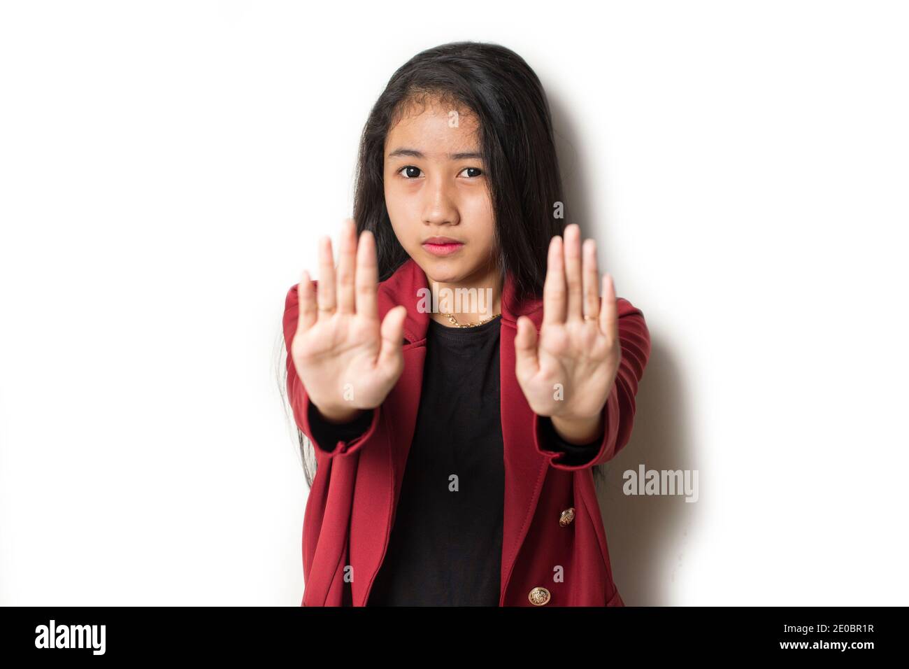 Asian woman making stop gesture with her hand isolated on a white ...