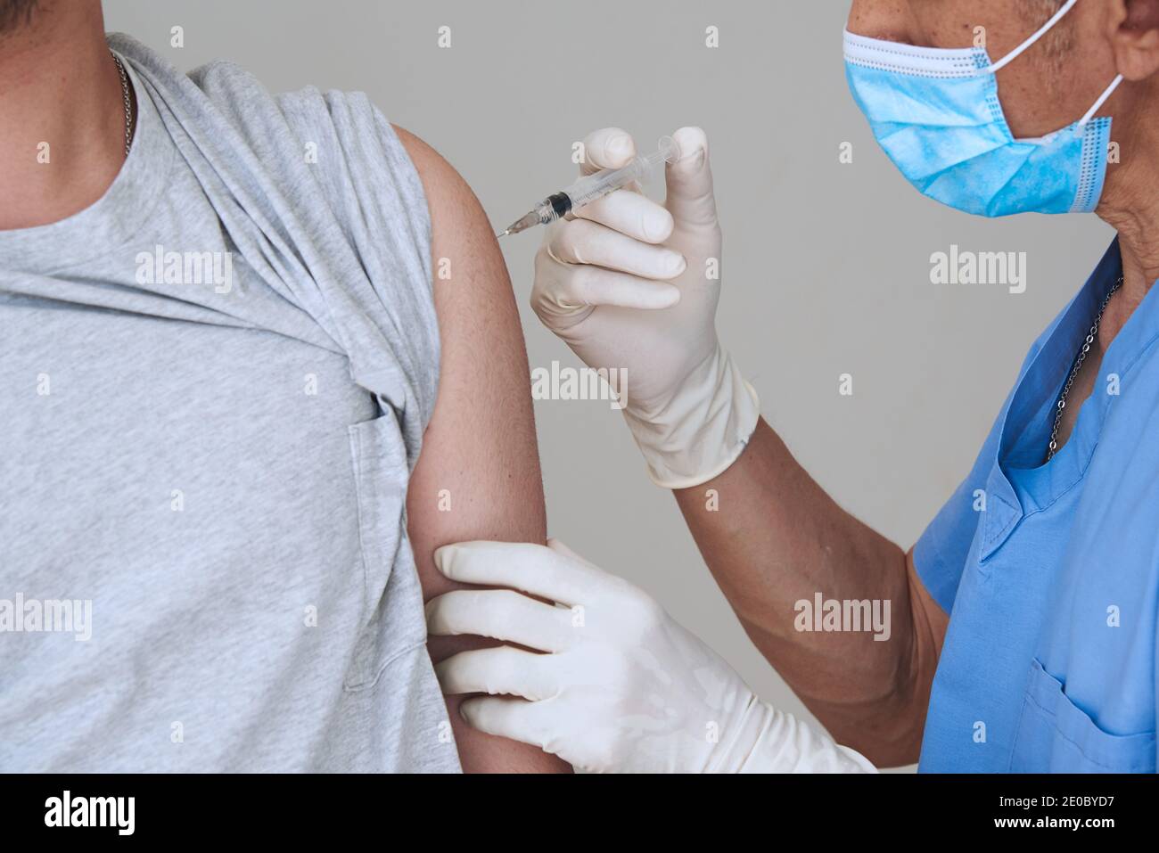 A doctor injecting a dose of vaccine at patient arm Stock Photo - Alamy