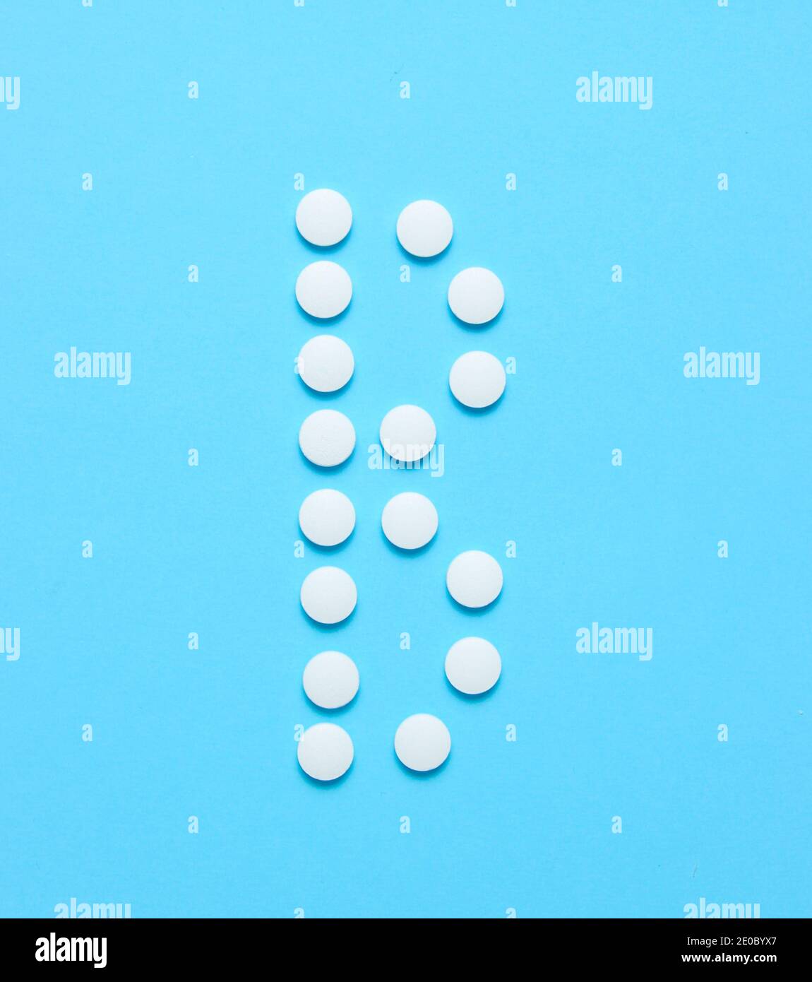 Vitamin B. Letter B from white pills on blue background. Minimalistic ...