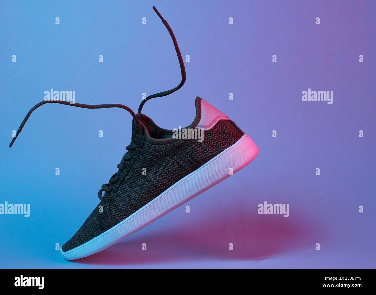 Sport sneakers with flying laces, retro futurism red blue neon light ...