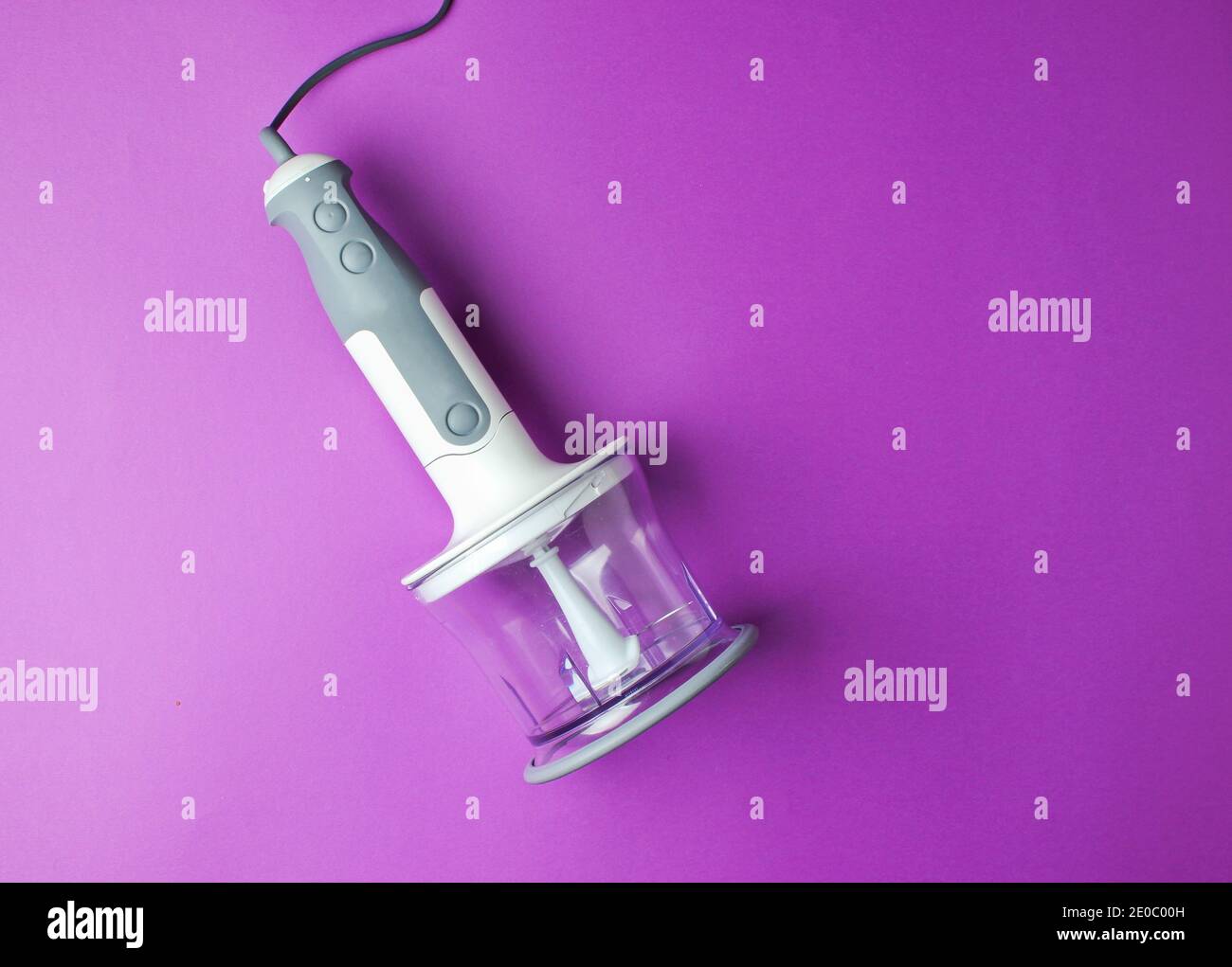 Electric hand blender with a jar on a purple background. Top view, Flat ...