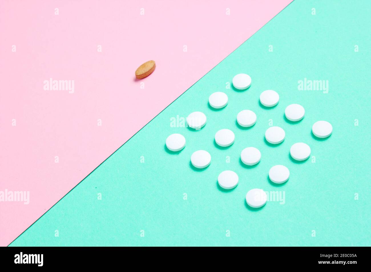 Minimalistic medical concept. A group of identical white tablets and ...