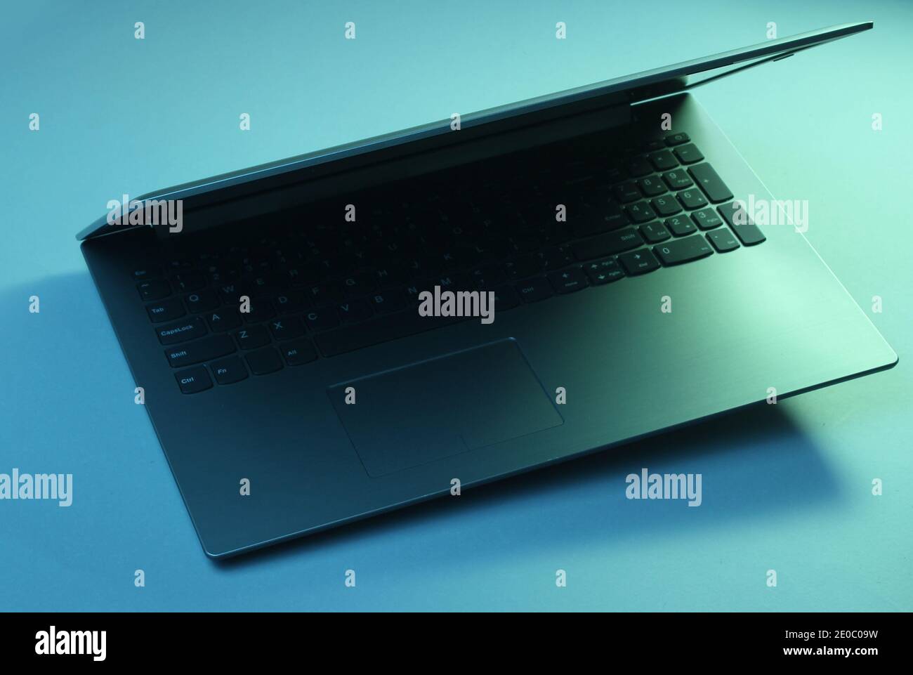 Modern laptop with vibrant gradient green blue holographic color lights ...