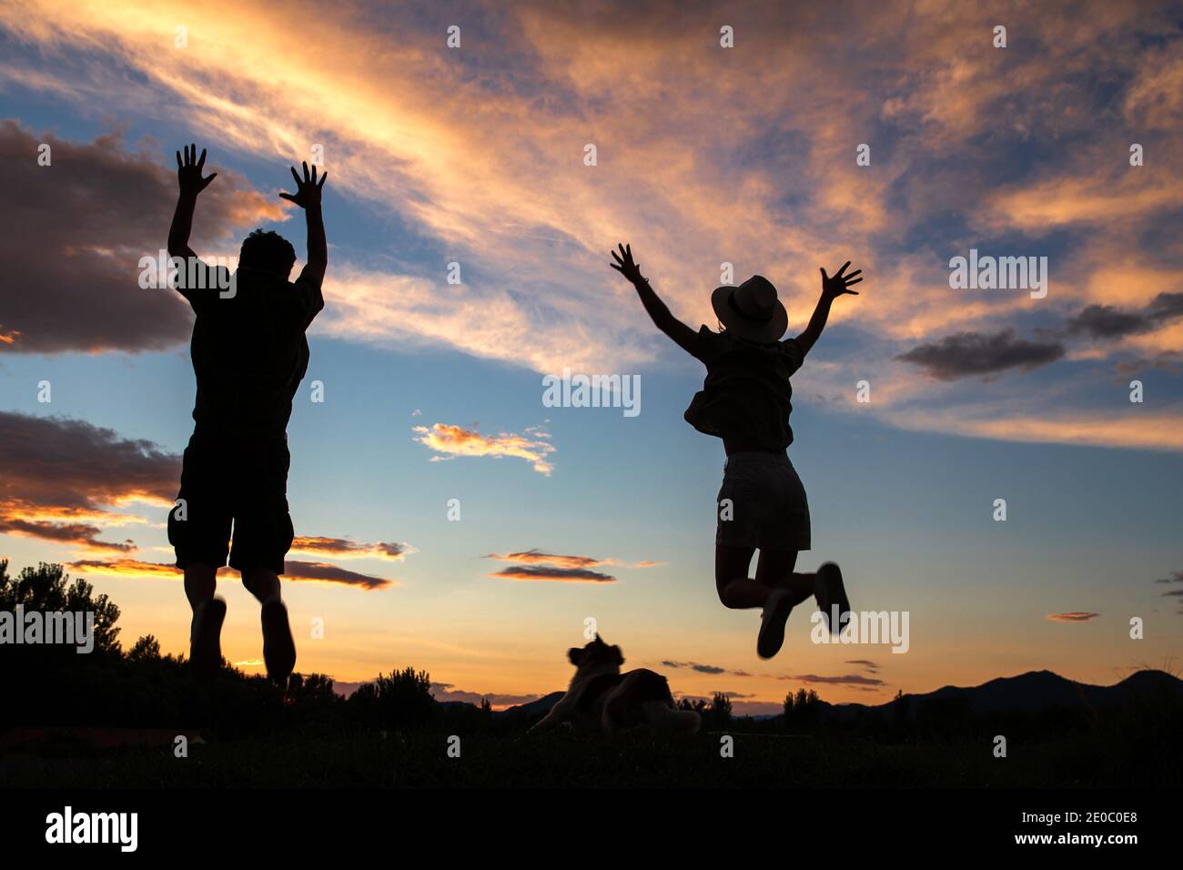 Two silhouette people jumping mid air hi-res stock photography and ...